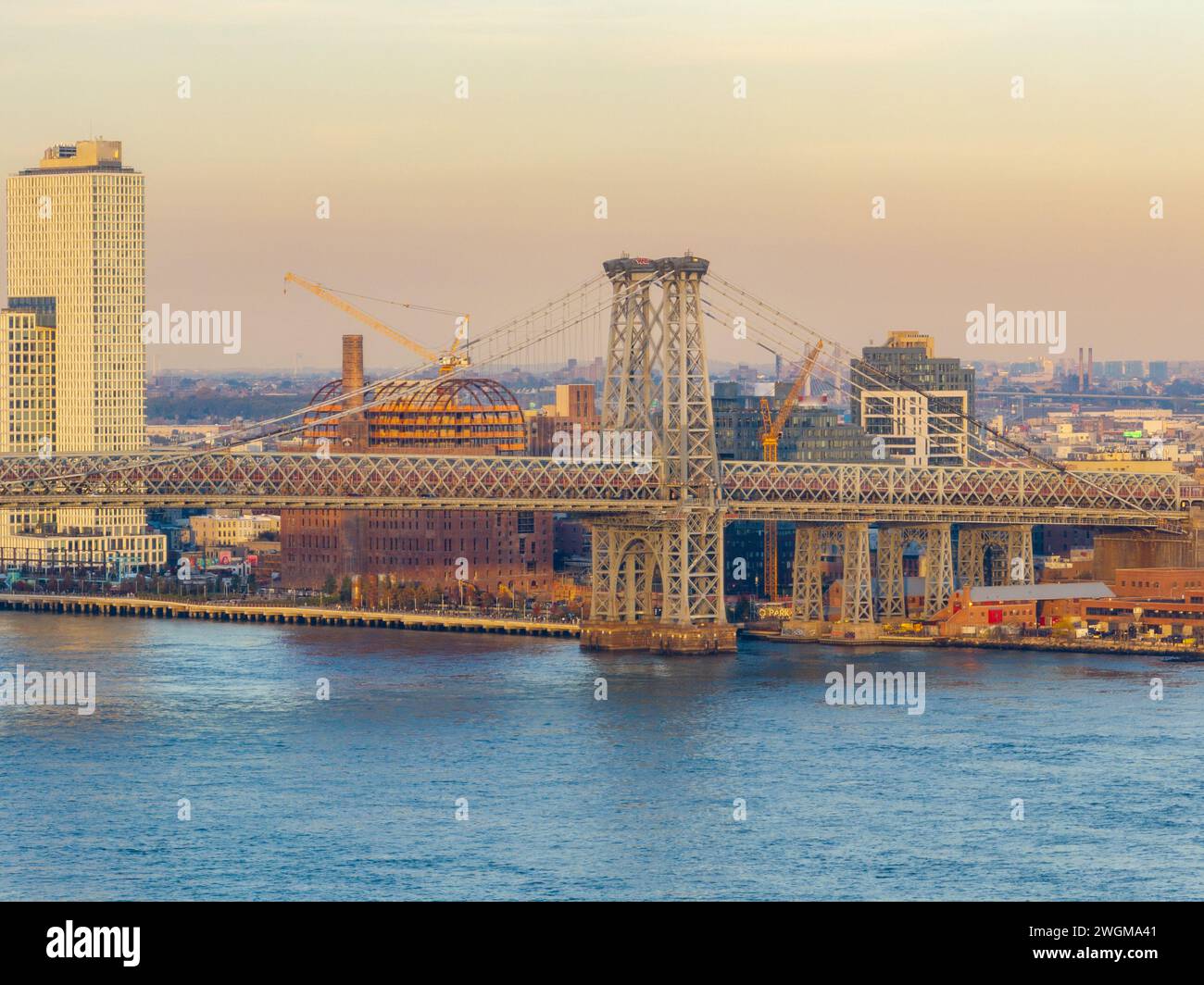 Aerial view of the Williamsburg Bridge spanning the East River with the ...