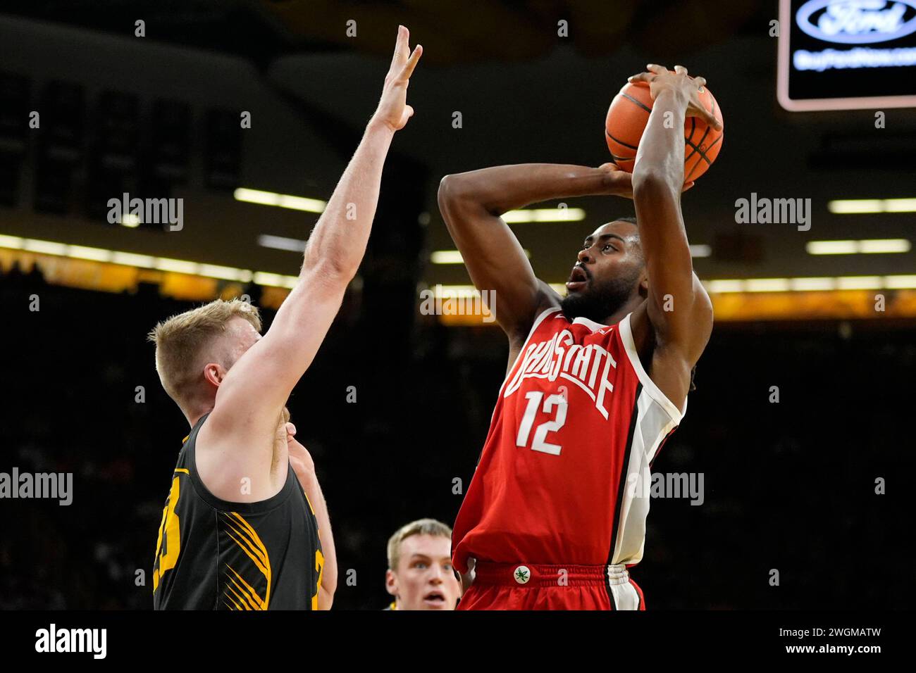 Ohio State guard Evan Mahaffey (12) shoots over Iowa forward Ben Krikke ...