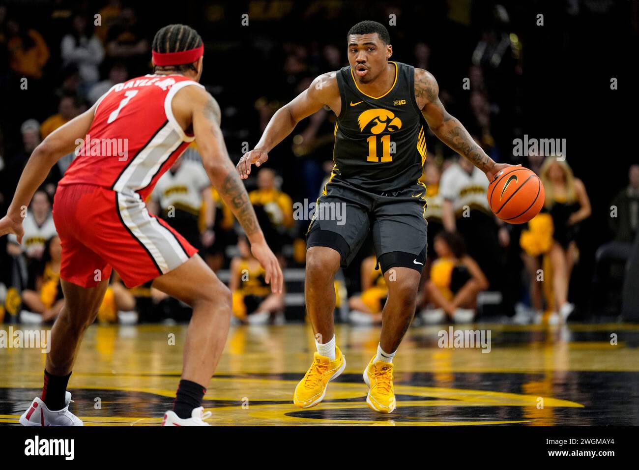 Iowa guard Tony Perkins (11) drvies up court in front of Ohio State ...