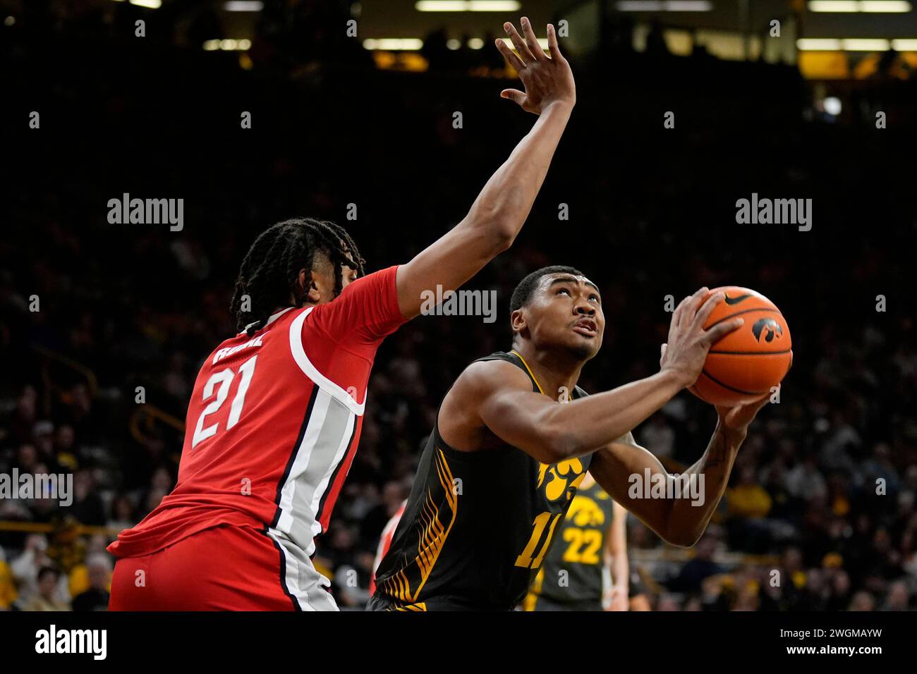 Iowa guard Tony Perkins (11) shoots over Ohio State forward Devin Royal ...