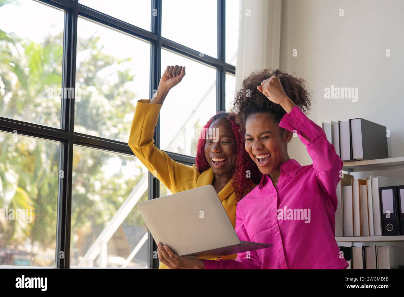 Two african woman celebrate when business goal success. achievement and ...