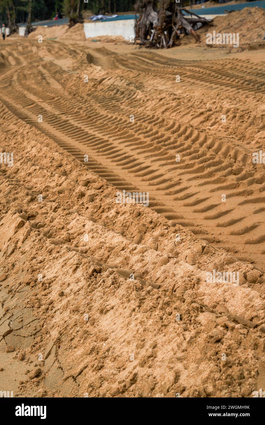 The wheel ruts of construction vehicles on the beach at the seaside ...
