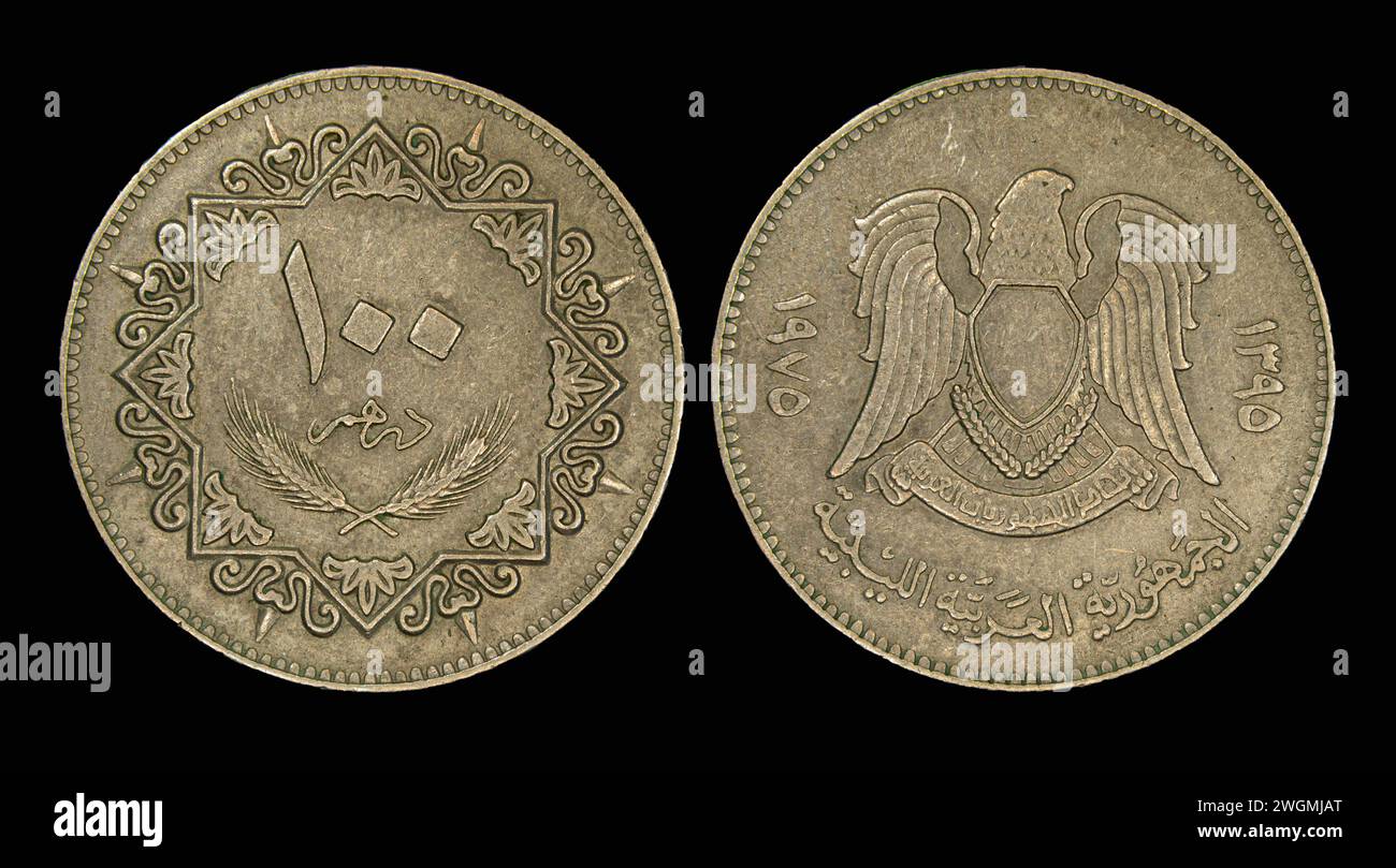 Two vintage Libyan Jamahiriya dinar coins placed on a vibrant black ...