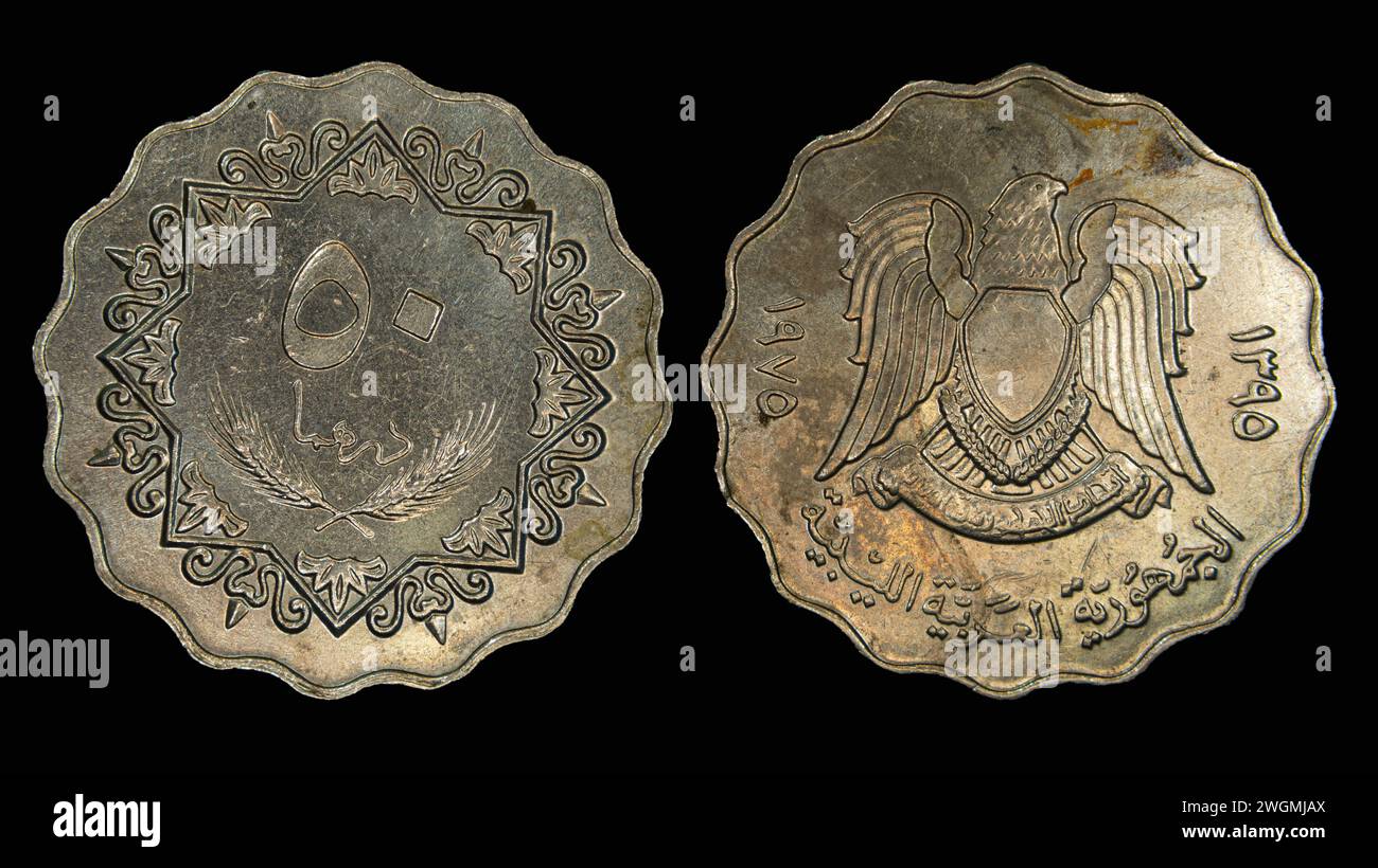 Two vintage Libyan Jamahiriya dinar coins placed on a vibrant black ...