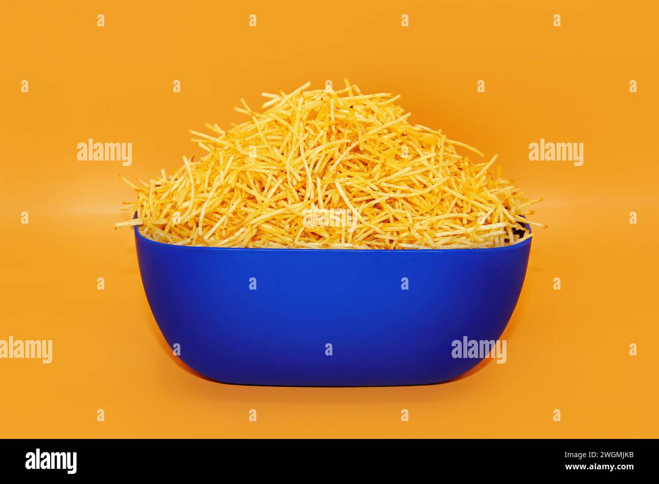 EXTRA THIN STRAW POTATOES IN VESSEL ON ISOLATED COLORFUL BACKGROUND ...