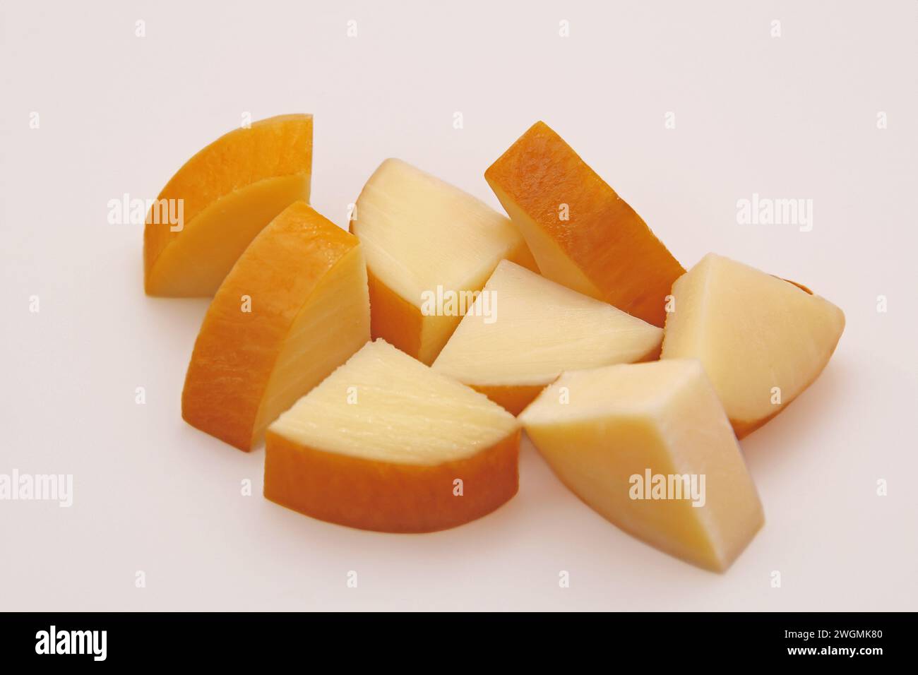 SMOKED PROVOLONE CHEESE CHOPPED INTO SMALL PIECES ON WHITE TABLE Stock ...