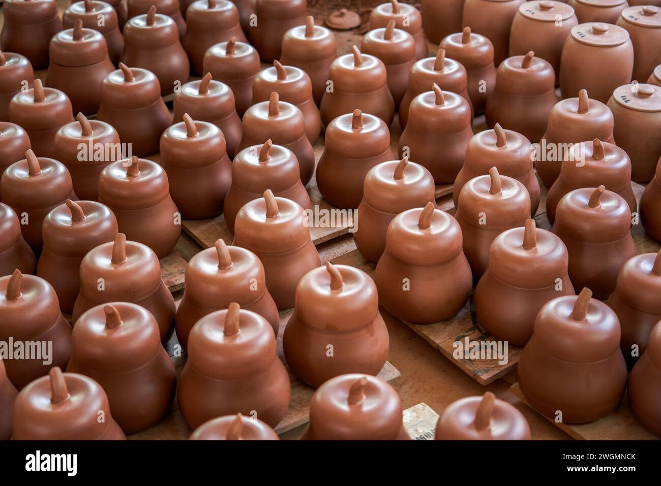 Neatly stacked clay embryos and molds in a traditional Chinese pottery ...