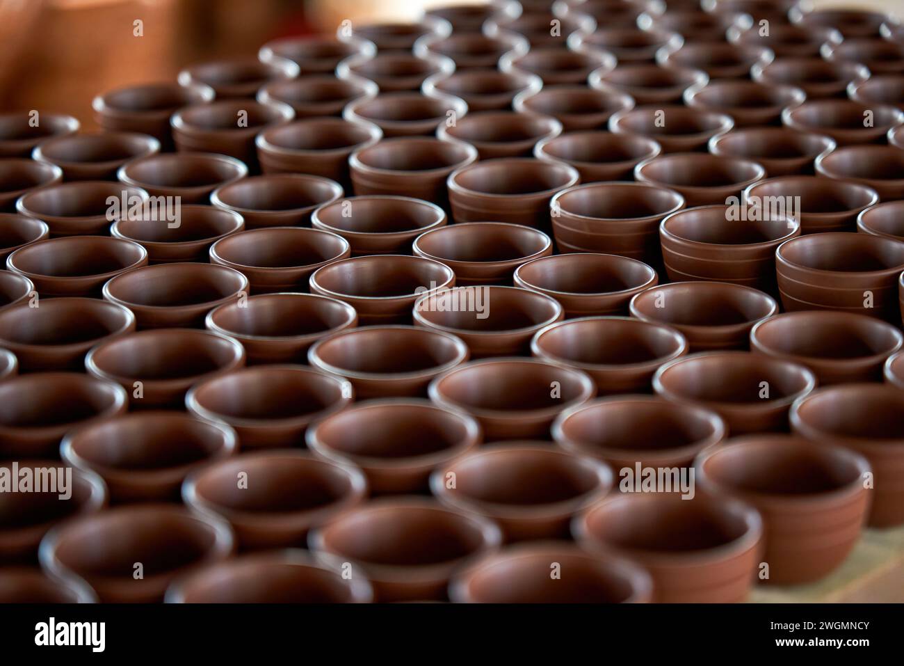 Neatly stacked clay embryos and molds in a traditional Chinese pottery ...