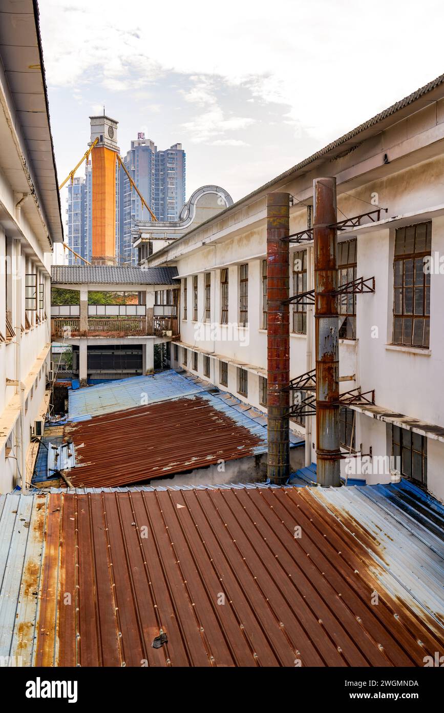 Rusty industrial workshop buildings and chimneys in an old industrial ...