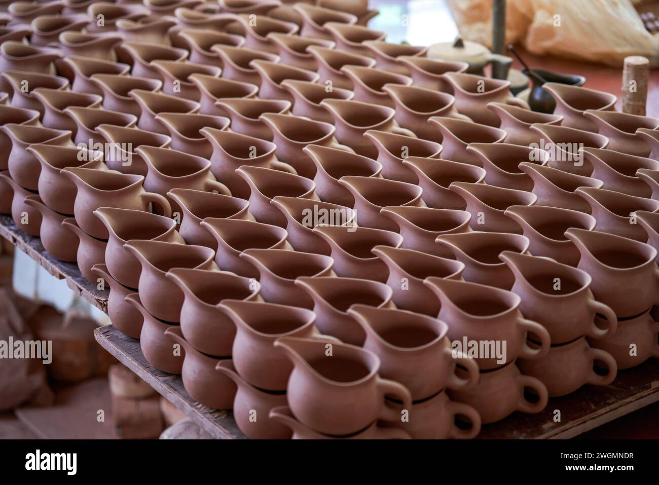 Neatly stacked clay embryos and molds in a traditional Chinese pottery ...