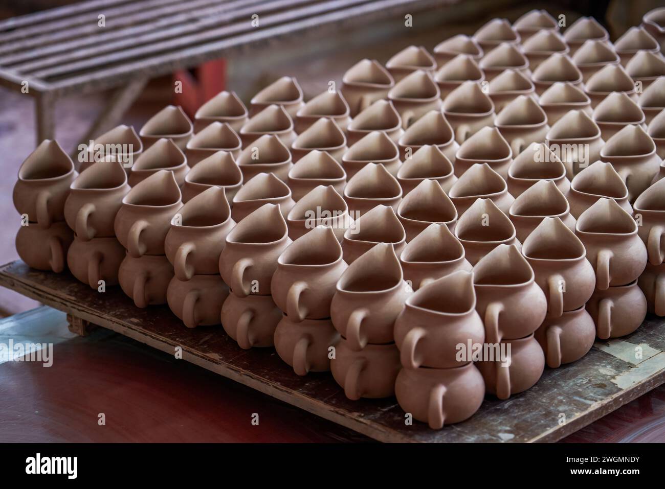 Neatly stacked clay embryos and molds in a traditional Chinese pottery ...