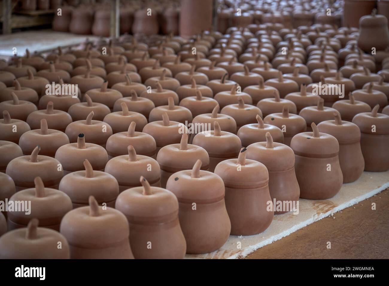Neatly stacked clay embryos and molds in a traditional Chinese pottery ...