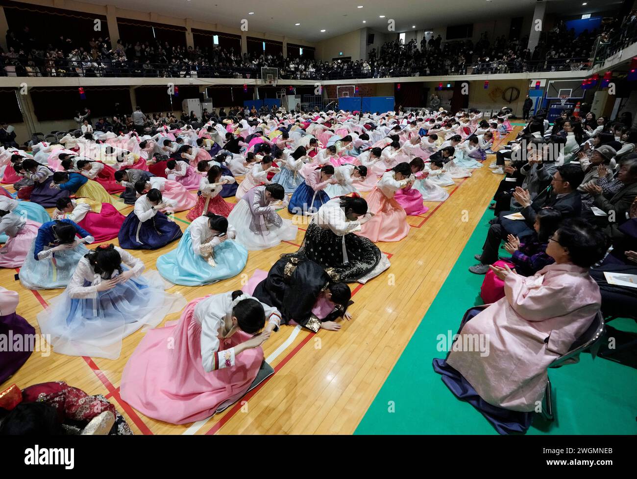 South Korean seniors clad in traditional attire bow to their teachers ...