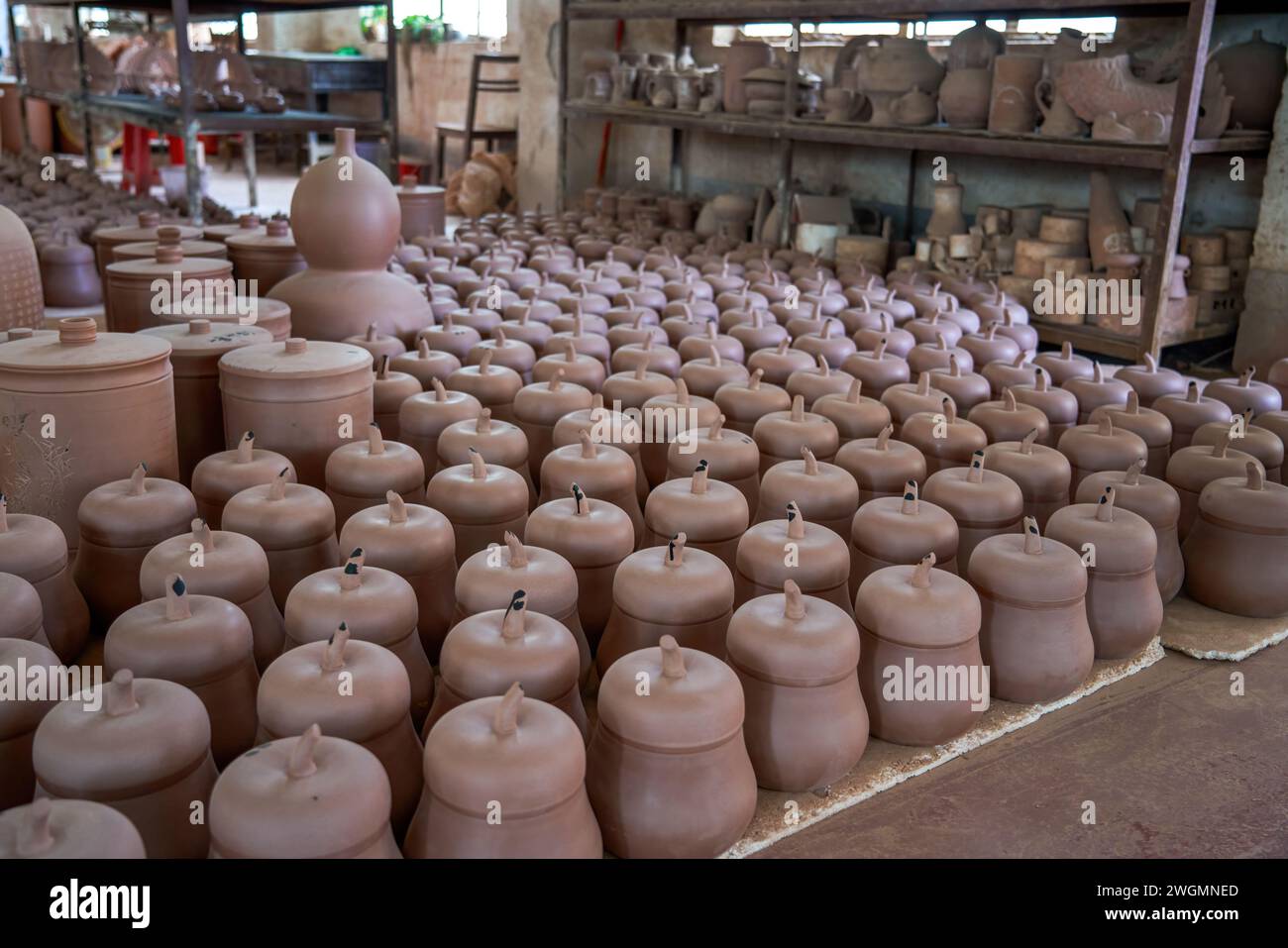 Neatly stacked clay embryos and molds in a traditional Chinese pottery ...