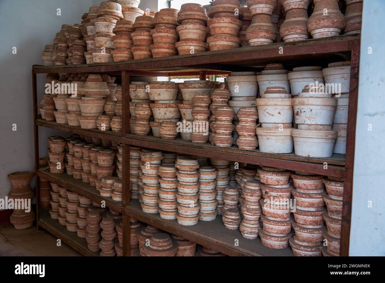 Neatly stacked clay embryos and molds in a traditional Chinese pottery ...