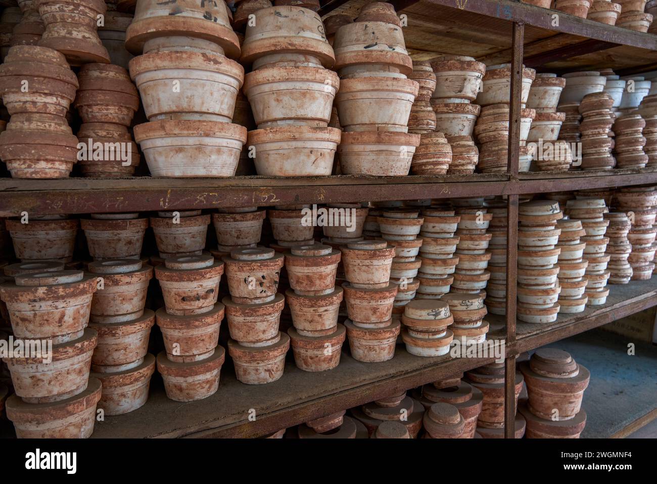 Neatly stacked clay embryos and molds in a traditional Chinese pottery ...