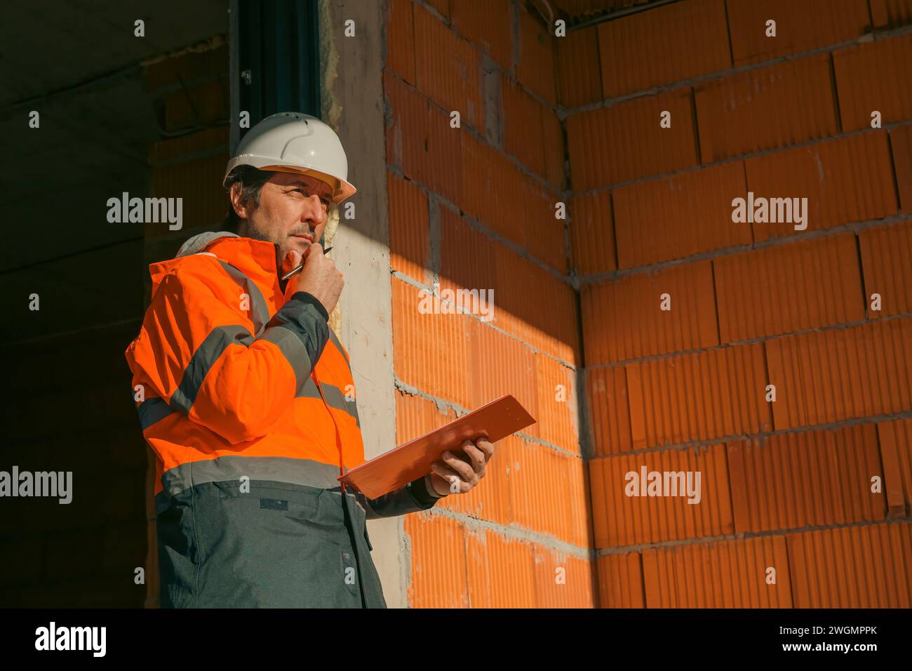 Building contractor and construction engineer making sketches and ...