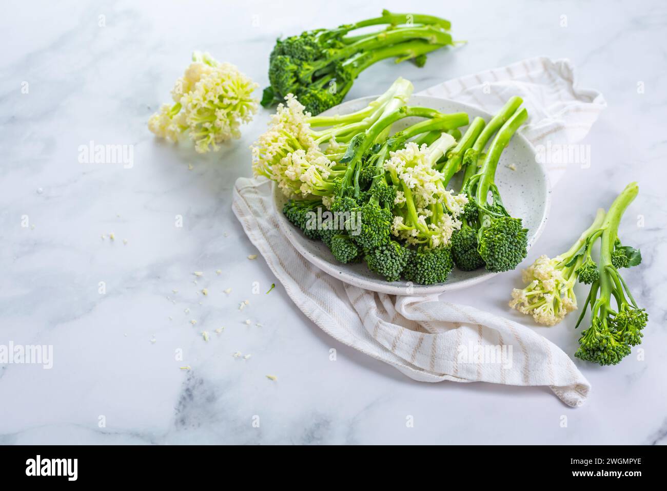 Fresh raw green bimi, broccolini and baby stick cauliflower in a bowl ...