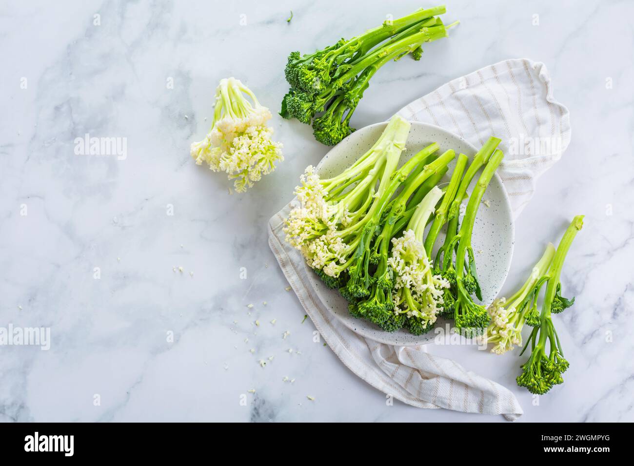 Fresh raw green bimi, broccolini and baby stick cauliflower in a bowl ...