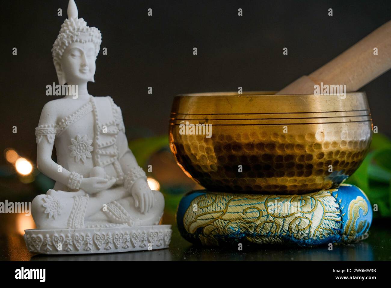 A hand hammered Tibetan bell with Buddha on a black background Stock ...