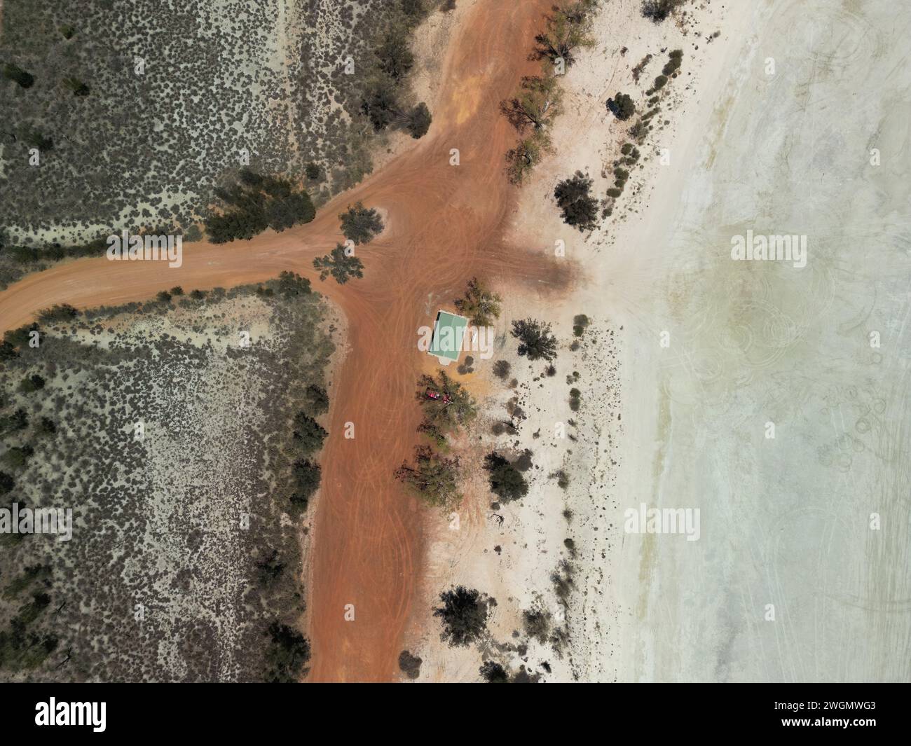 An aerial view of a red road next to dry salt pan Lake Ninan in Western ...
