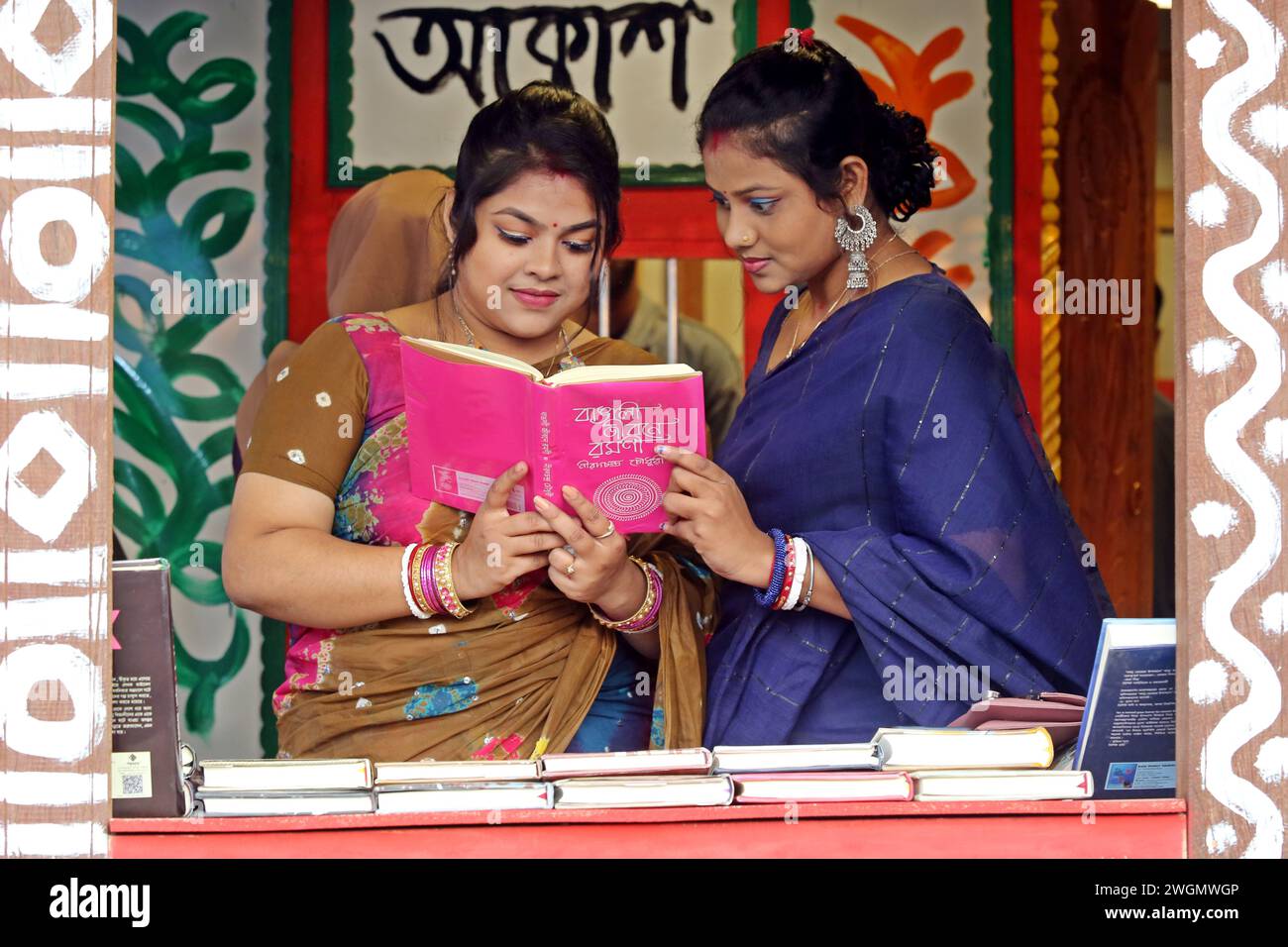 Dhaka, Wari, Bangladesh. 5th Feb, 2024. Visitors read books at the national book fair named ...