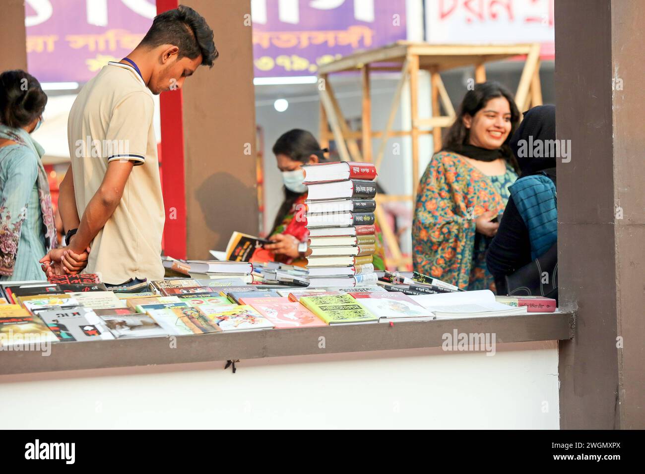 Buchmesse in Dhaka Visitors read books at the national book fair named ...