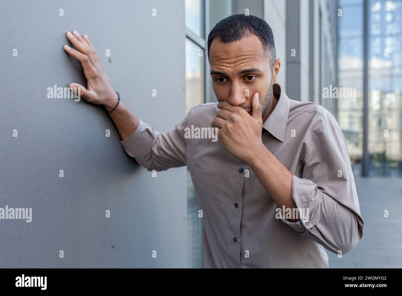 Sick arab male covering mouth with hand while heaving nausea and ...