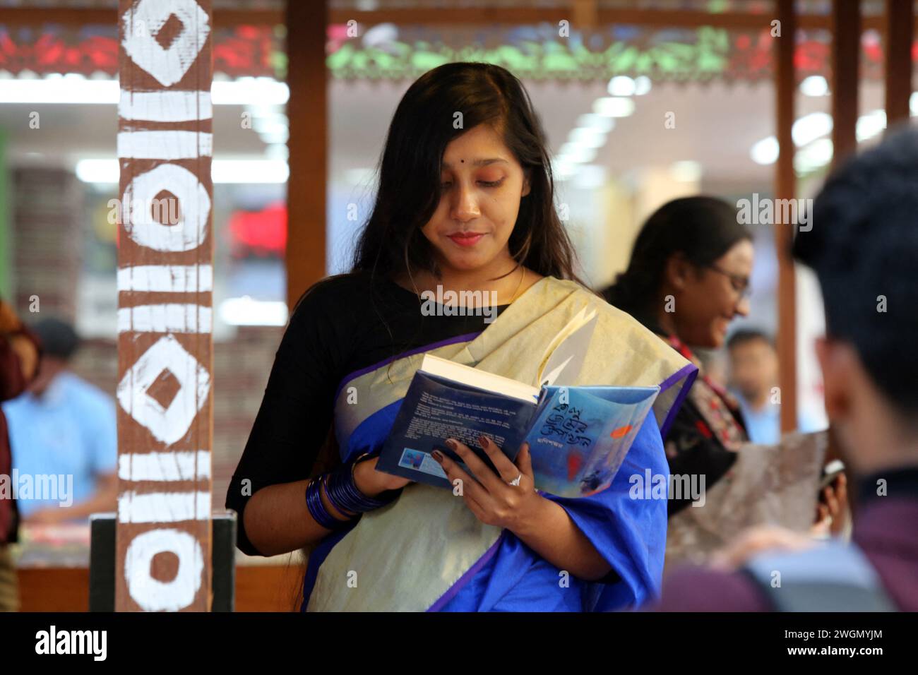 Dhaka, Bangladesh. 06th Feb, 2024. Visitors read books at the national book fair named Ekushey ...