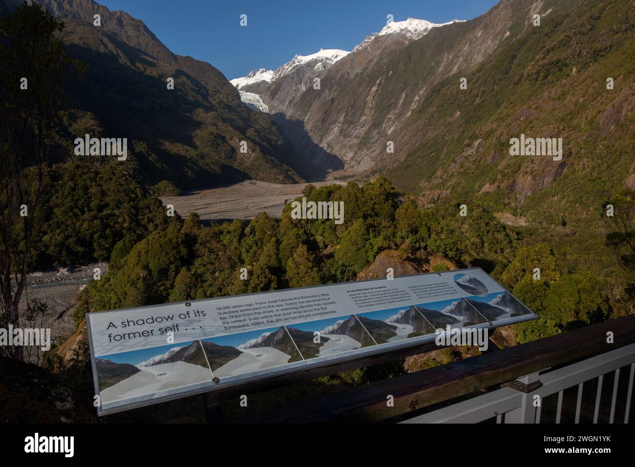 Sign showing how glacier has receded and view of Franz Josef Glacier ...