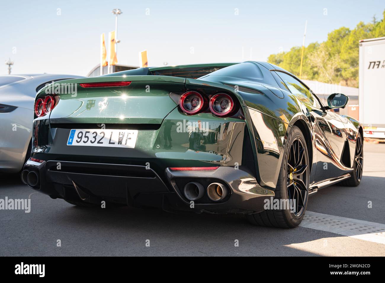 Rear view of the modern and stunning and elegant dark green Ferrari 812 ...