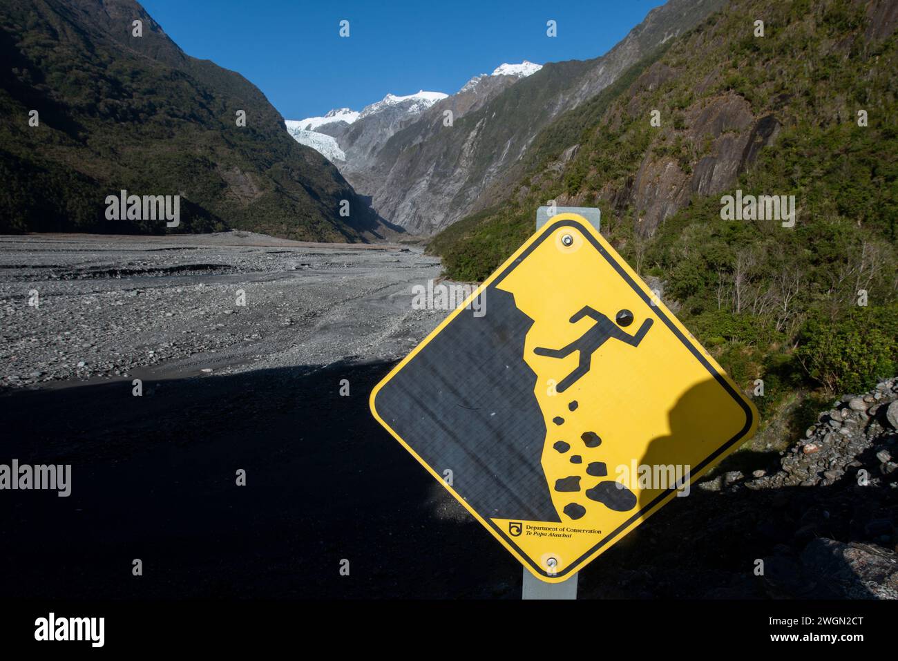 Sign warning of loose rocks and view of Franz Josef Glacier, Franz ...