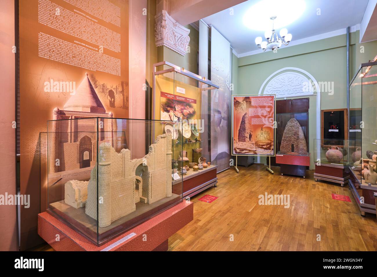 A gallery with ancient artifacts, including a mausoleum model and old ...
