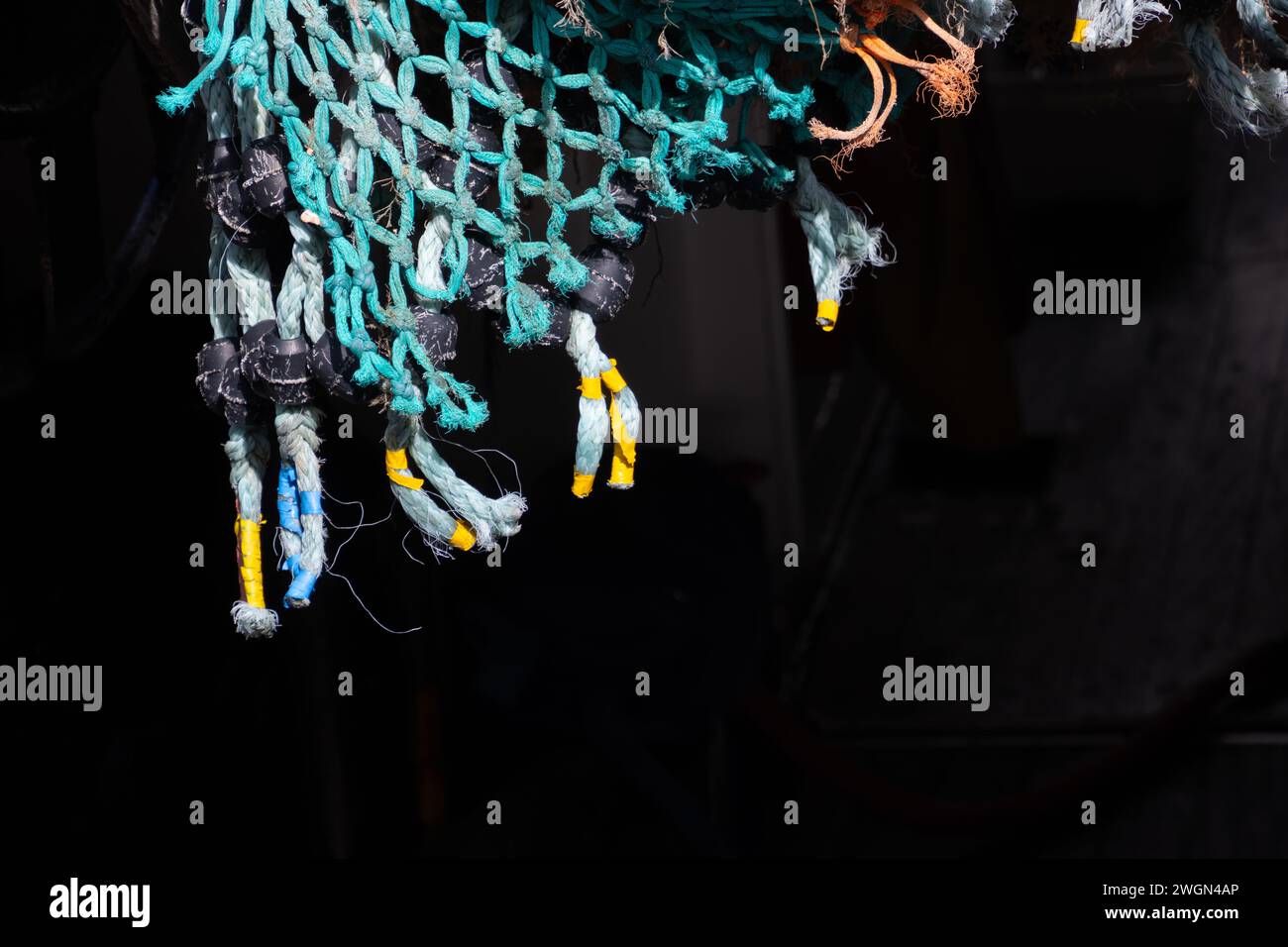 Close up of a green tied net hanging down Stock Photo - Alamy