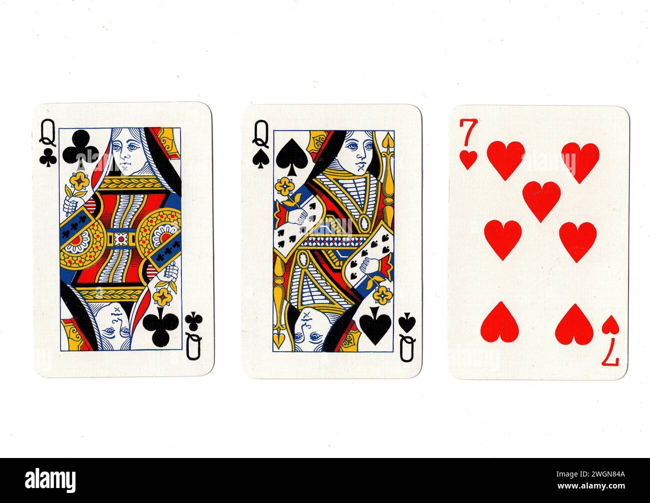 Vintage playing cards showing a pair of black queens and a red seven ...