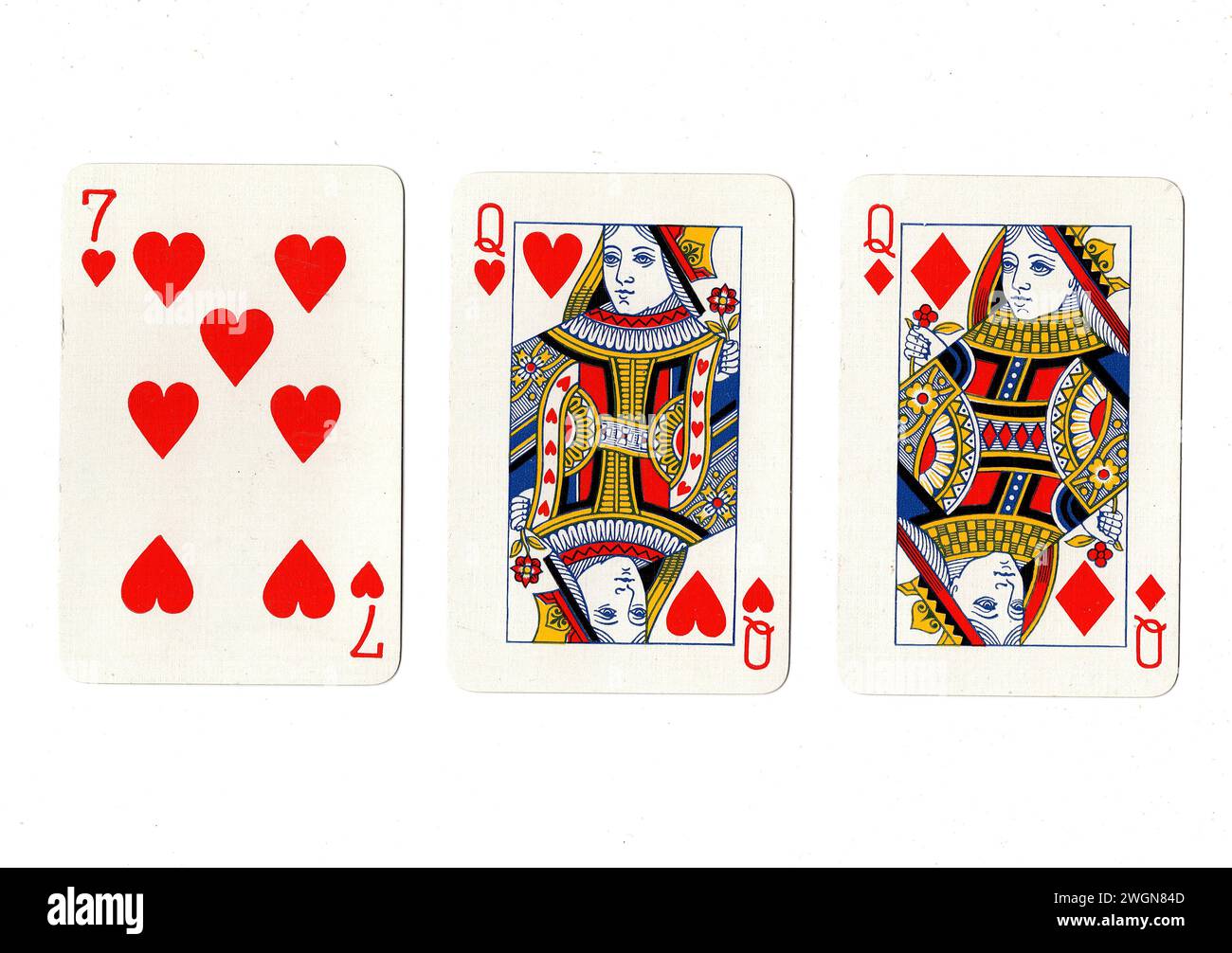 Vintage playing cards showing a pair of red queens and a red seven ...
