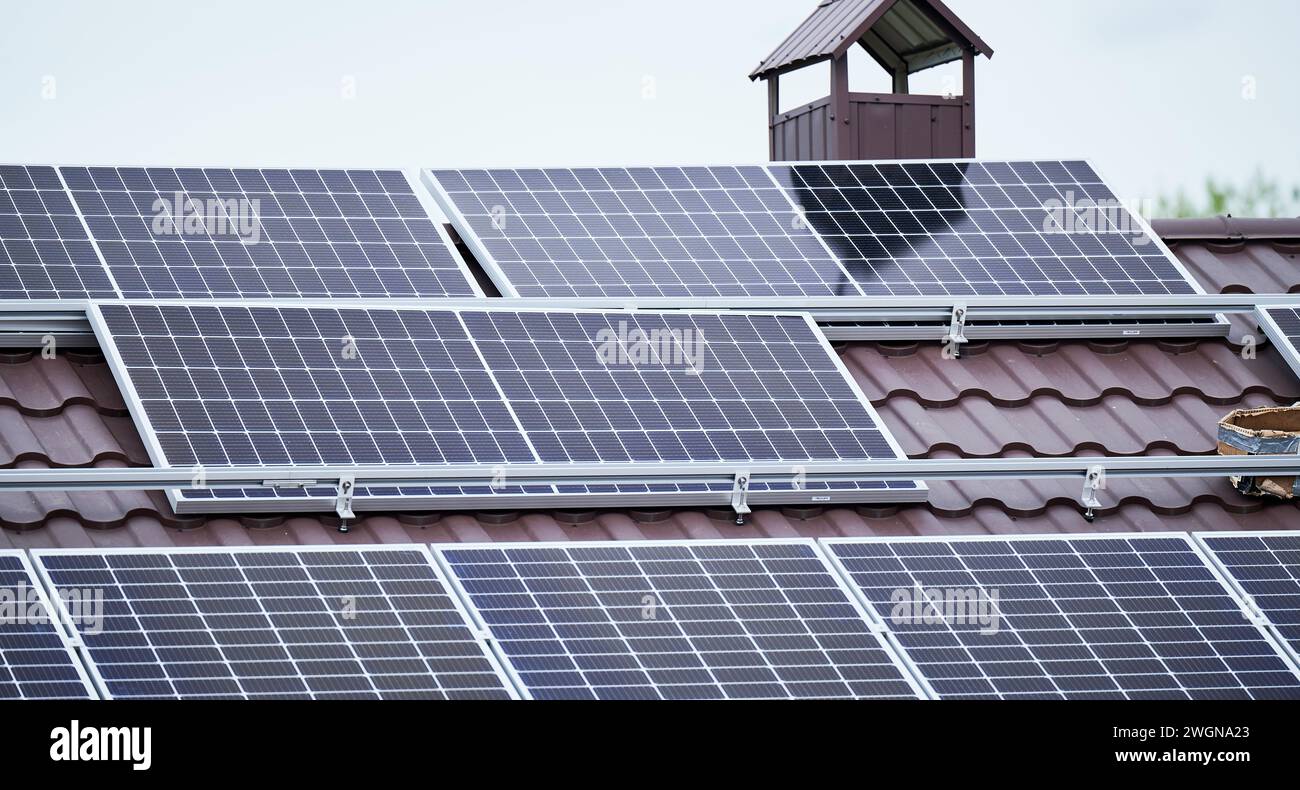 Solar photovoltaic panel system on modern house roof Stock Photo - Alamy