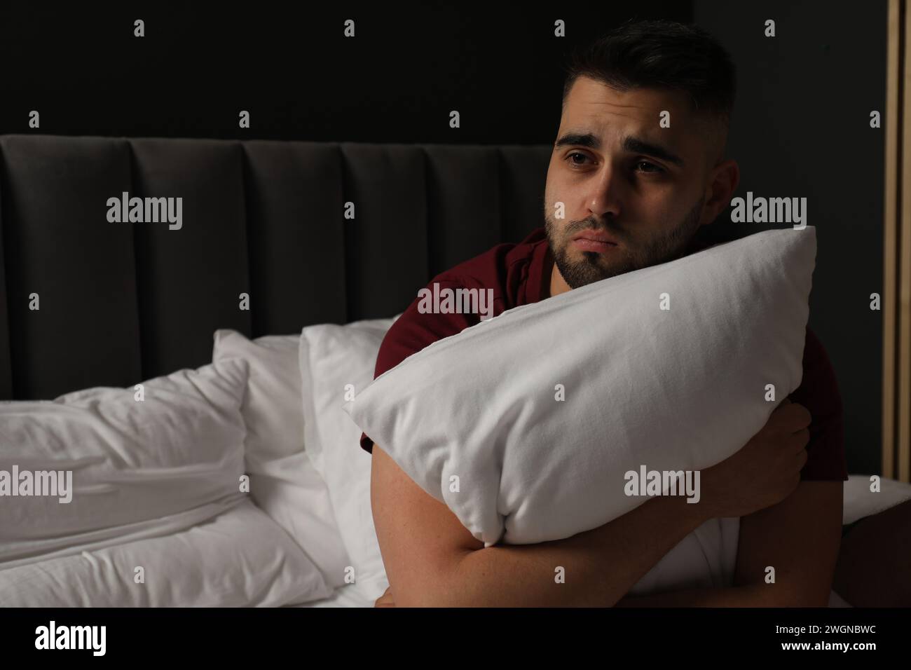 Sad unhappy man hugging pillow hi-res stock photography and images - Alamy