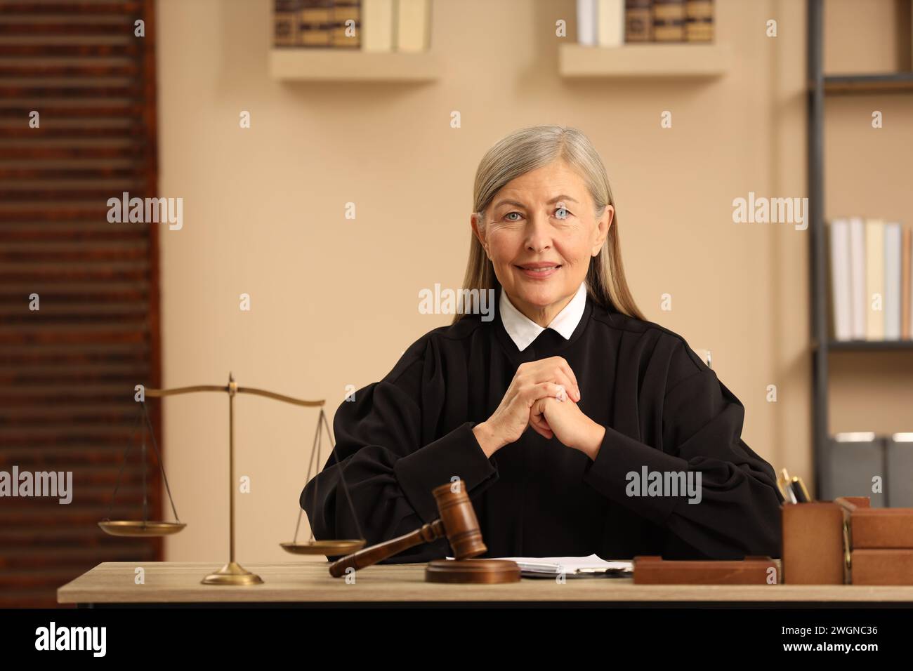 Judge in court dress working at table indoors. Space for text Stock ...