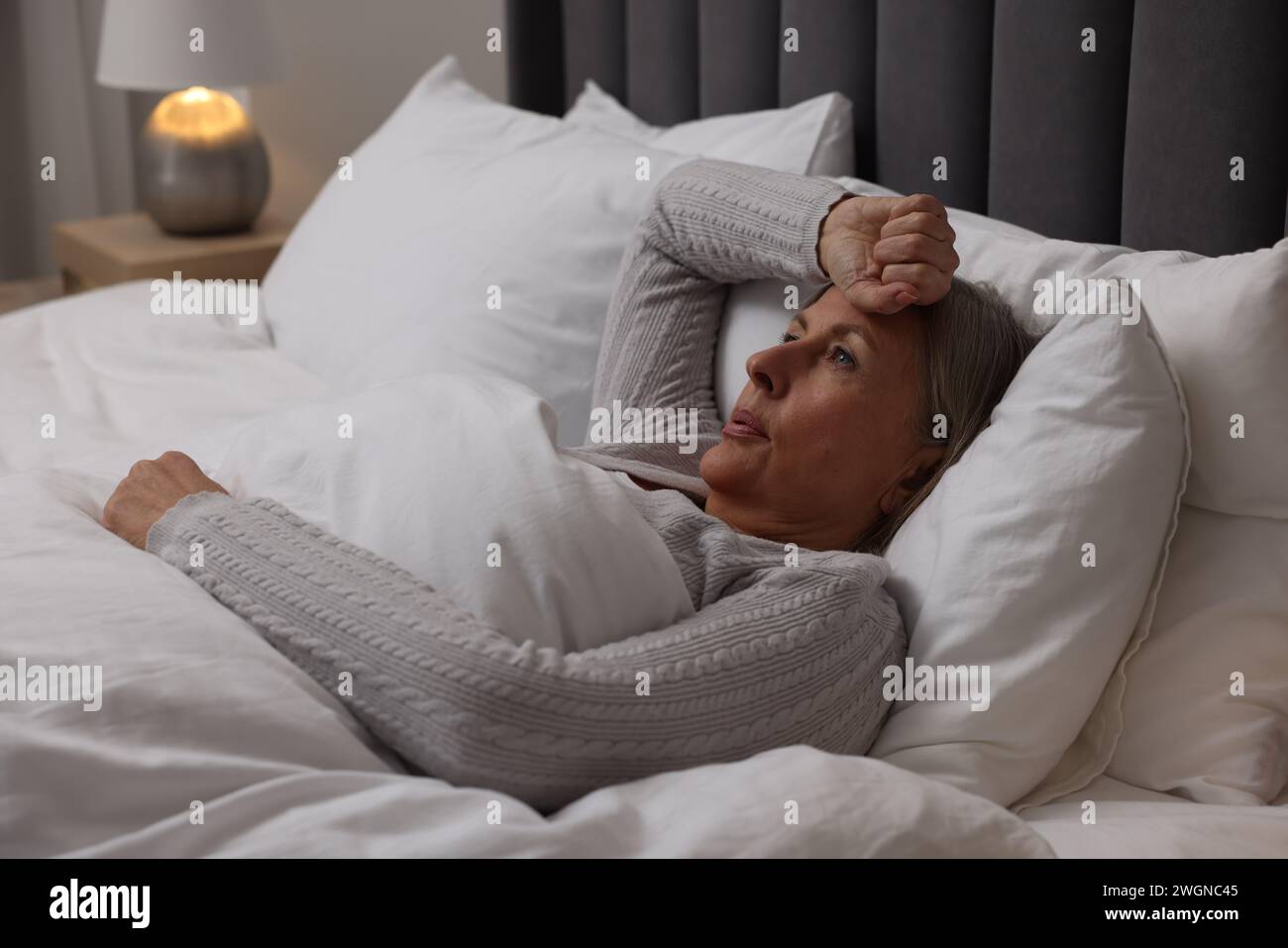 Menopause, night sweat. Woman suffering from hot flash in bed Stock ...