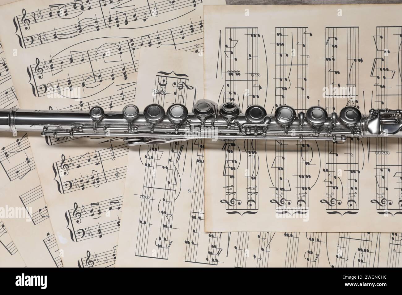 Classical flute on sheets with musical notes, top view Stock Photo - Alamy