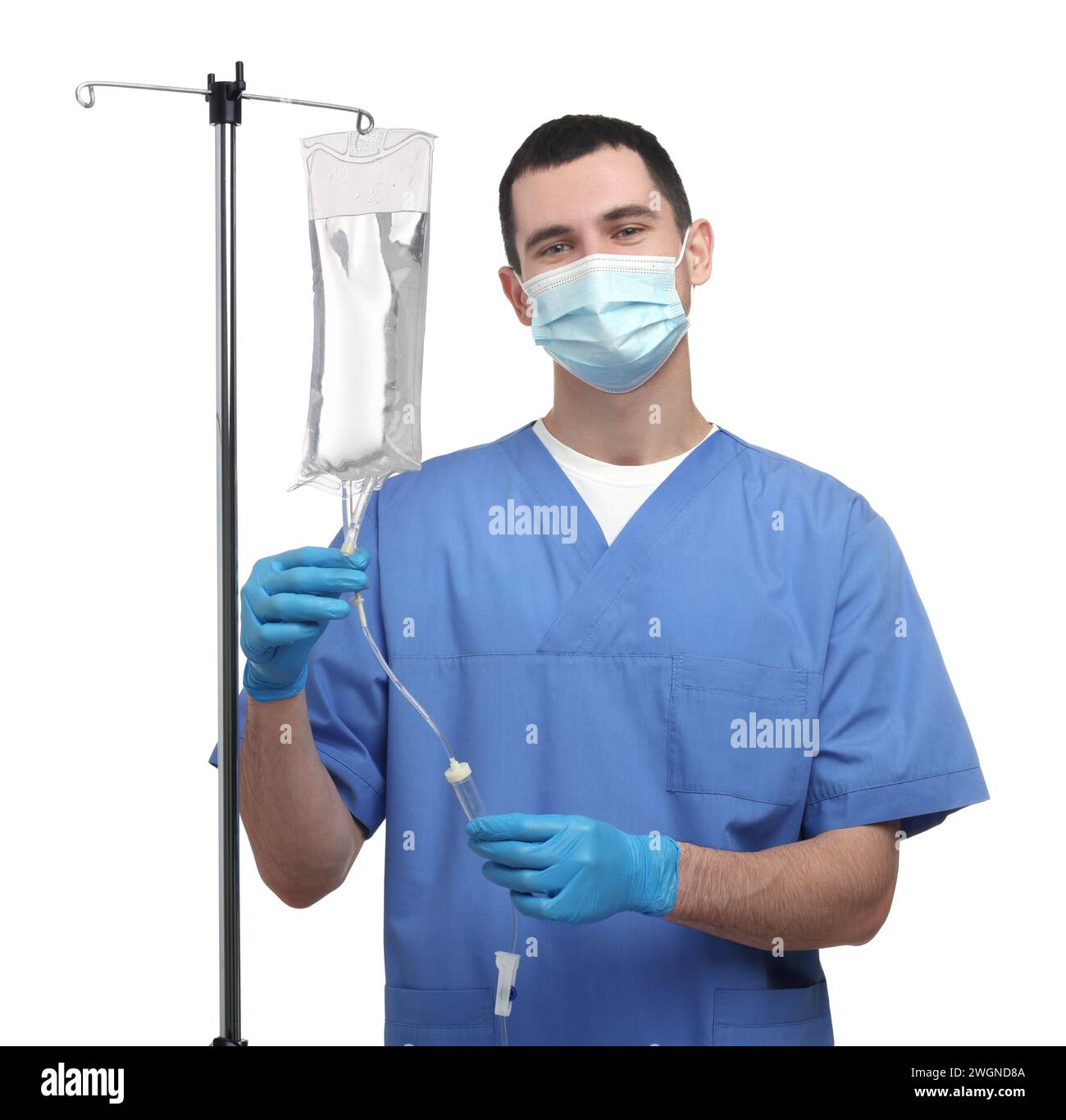 Nurse setting up IV drip on white background Stock Photo - Alamy