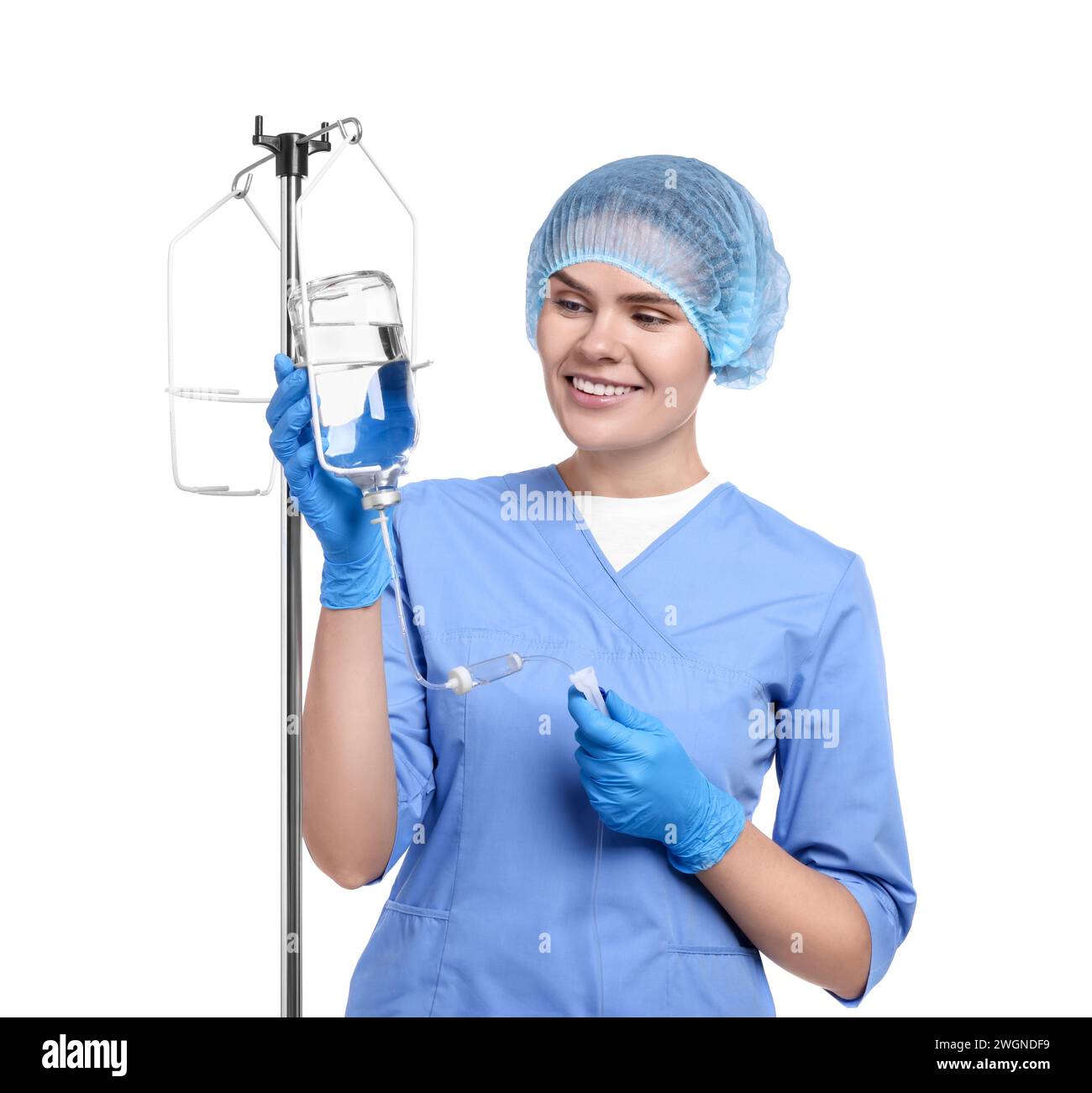 Nurse setting up IV drip on white background Stock Photo - Alamy
