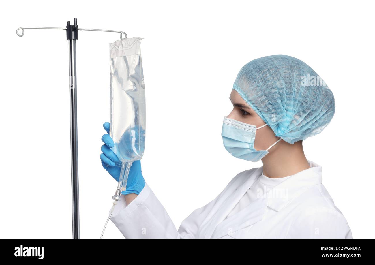 Nurse setting up IV drip on white background Stock Photo - Alamy