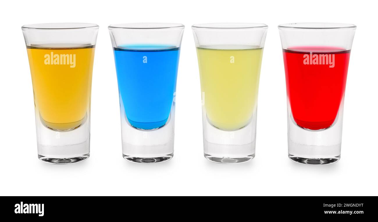 Different shooters in shot glasses isolated on white. Alcohol drink ...