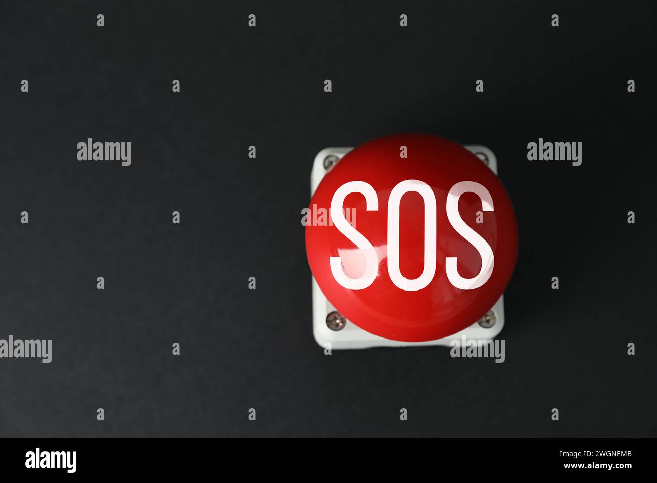 Red SOS button on black background. Space for text Stock Photo - Alamy