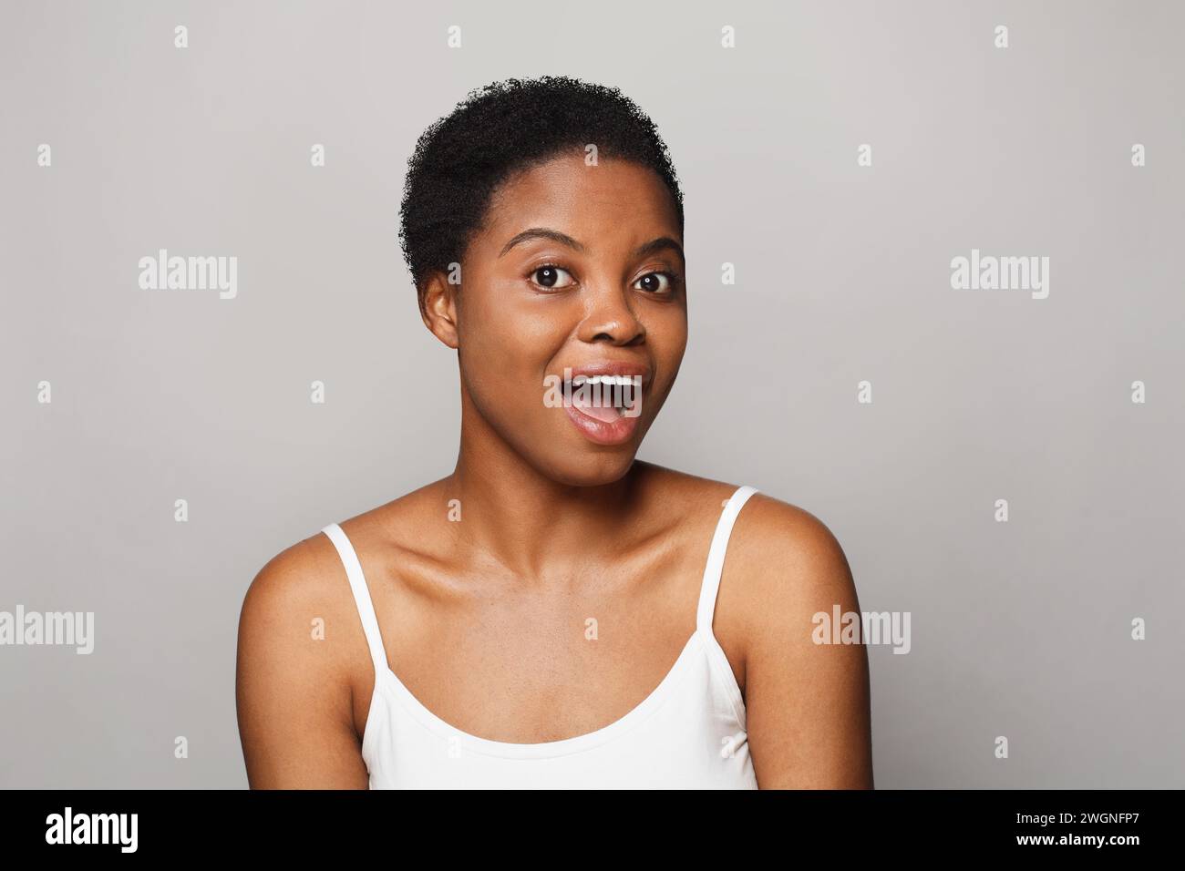 Surprised african american female model with healthy fresh clear dark ...