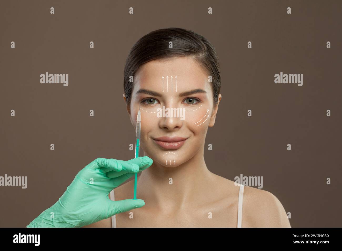 Attractive woman with arrow lines on her face for lifting skin and ...