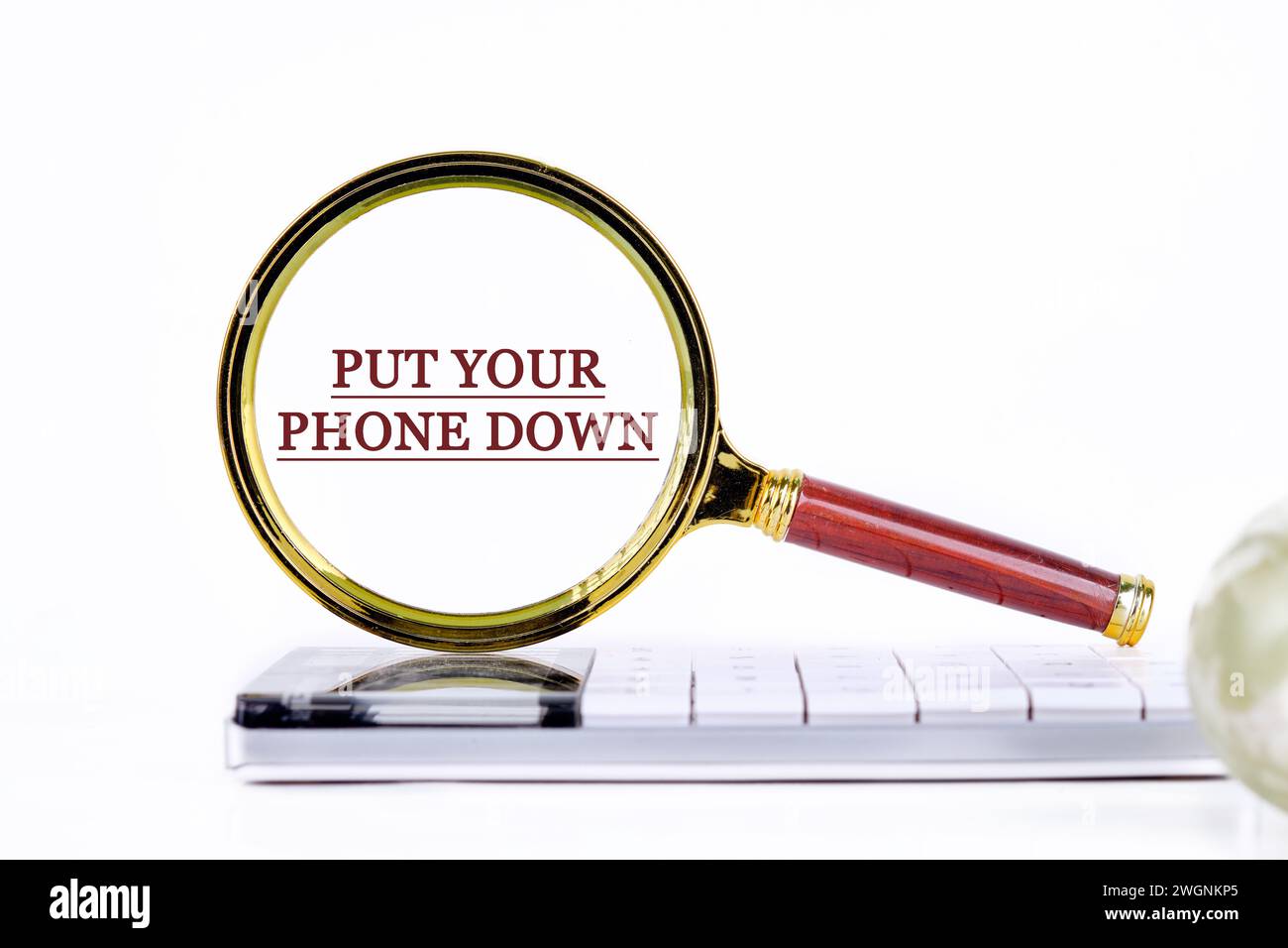 Put Your Phone Down text written through a magnifying glass on a ...