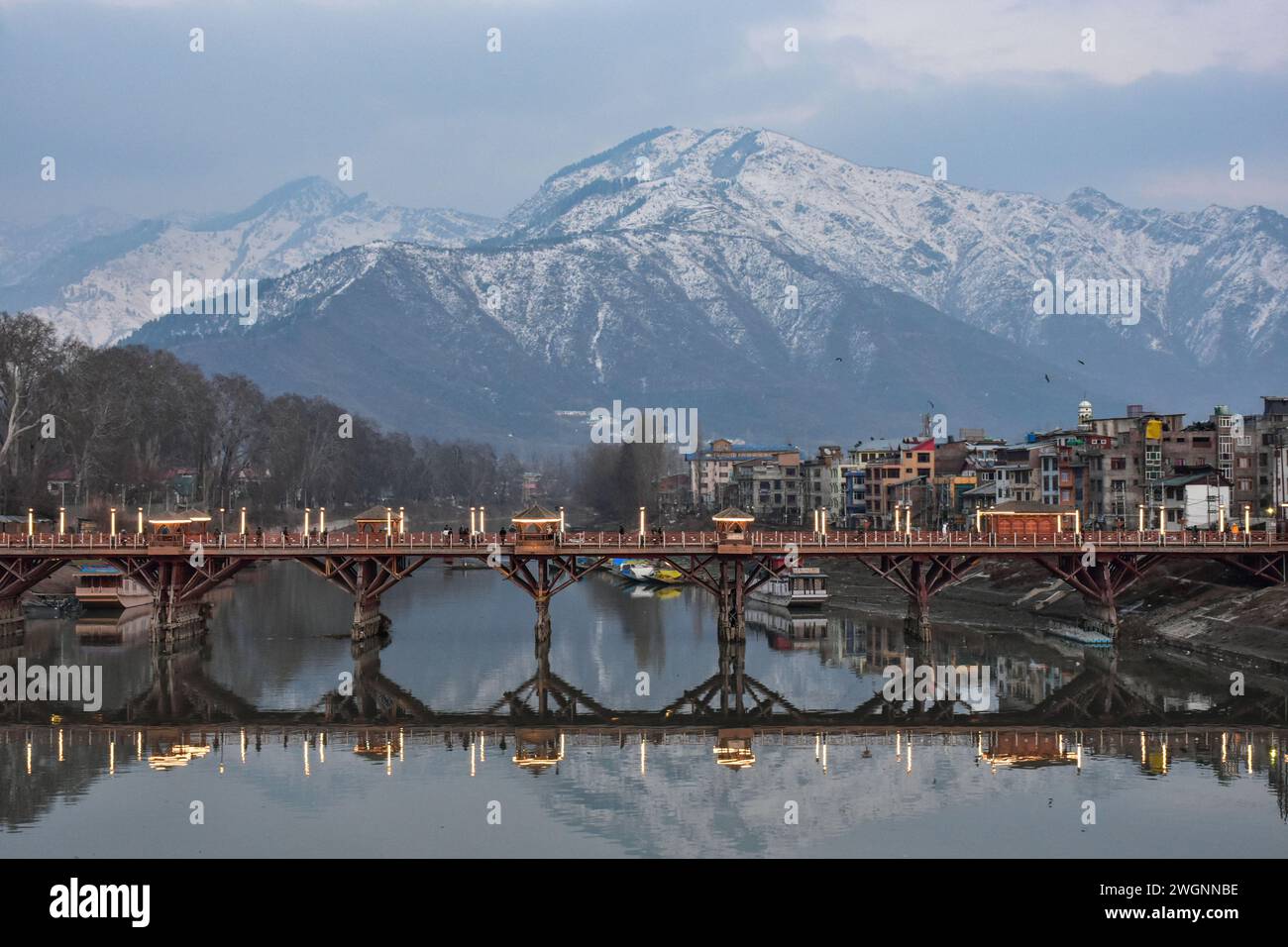 Commuters walk along the wooden foot-bridge during a cold winter ...